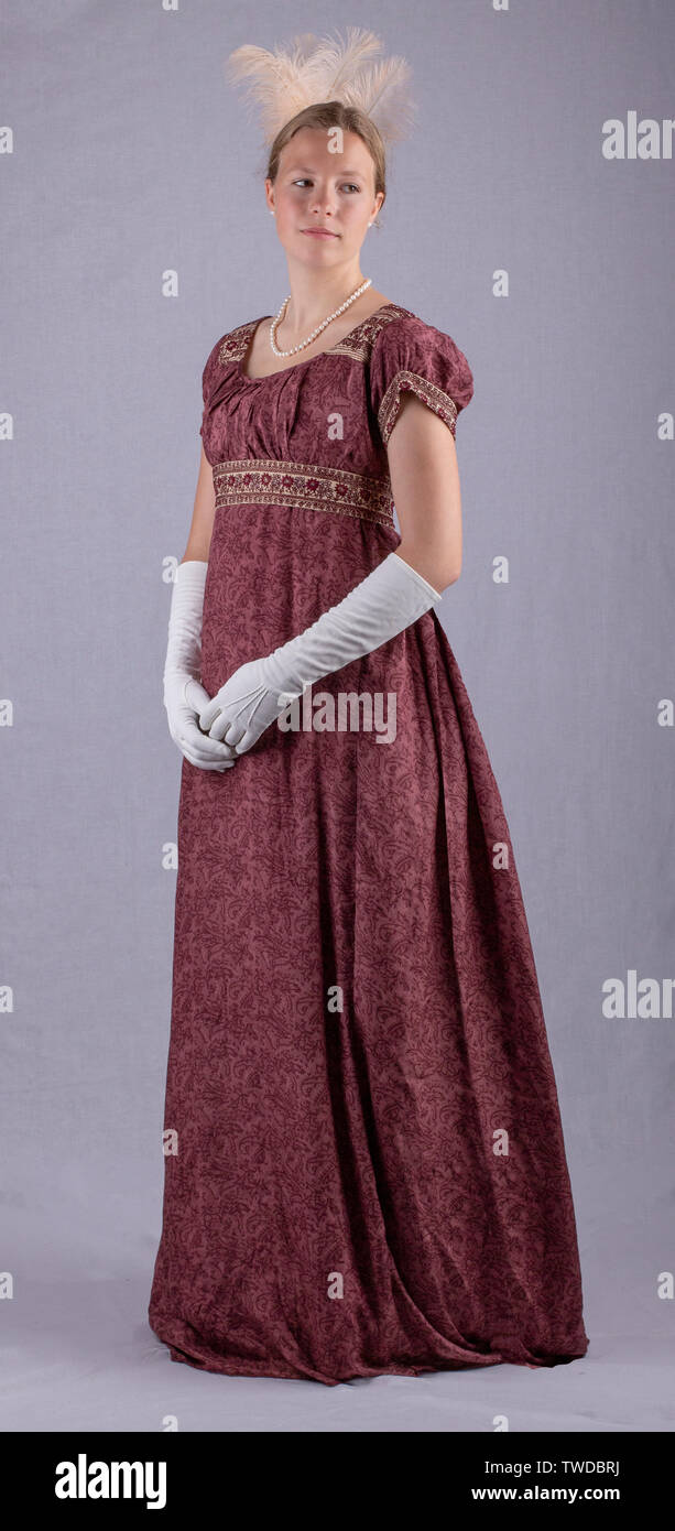 Regency woman in red evening dress with feathers in her hair Stock ...