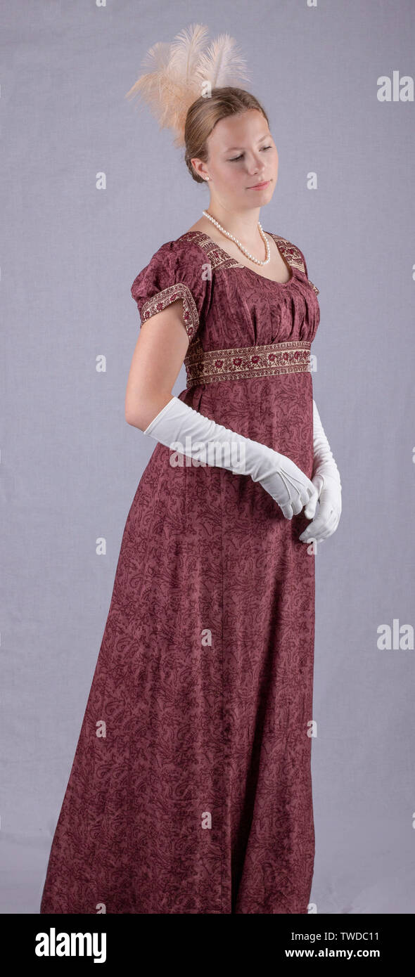 Regency woman in red evening dress with feathers in her hair Stock ...