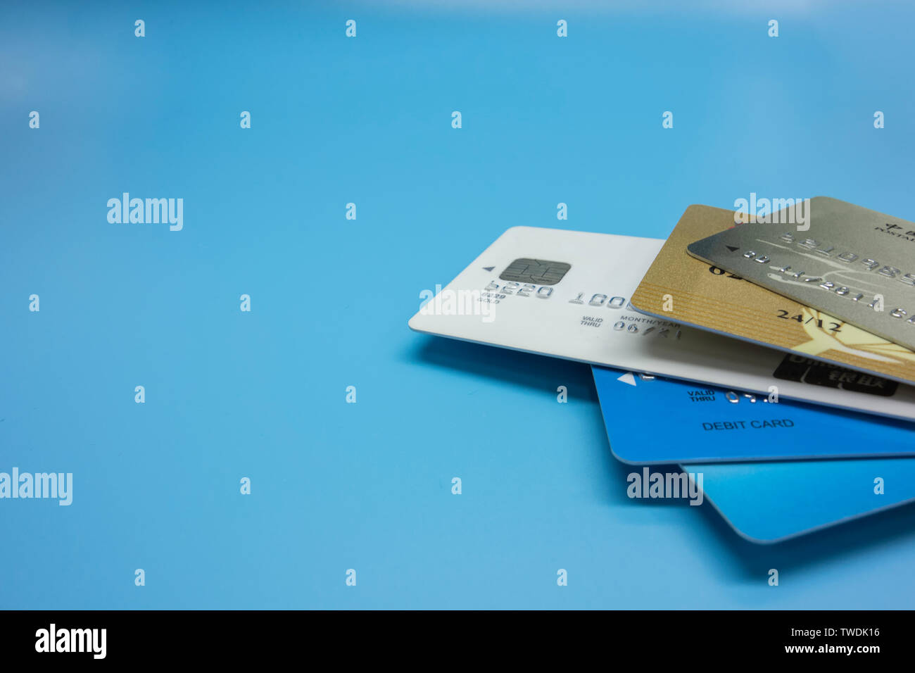 Bank cards stacked together in a blue background Stock Photo - Alamy