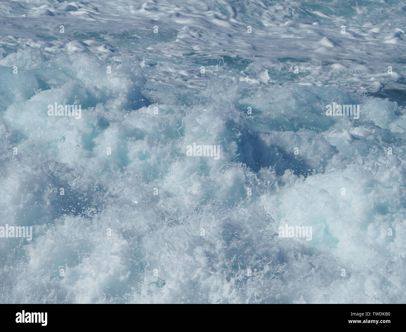 frothy white surf, pastel blue water, winterlooking like a pale blue ...
