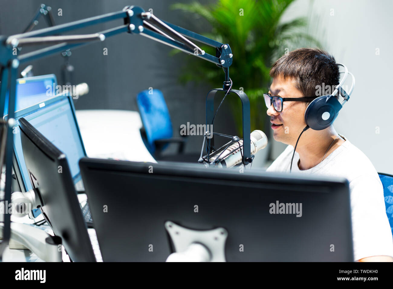 young man dj works in modern broadcast studio Stock Photo - Alamy