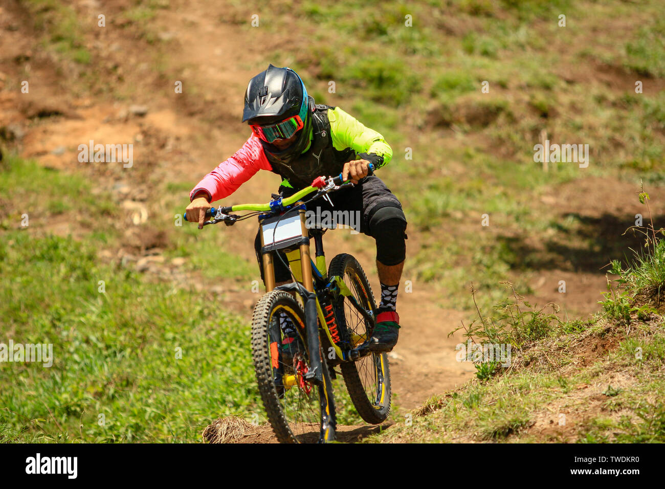 A professional down hill cyclist racer in a competition, full ...