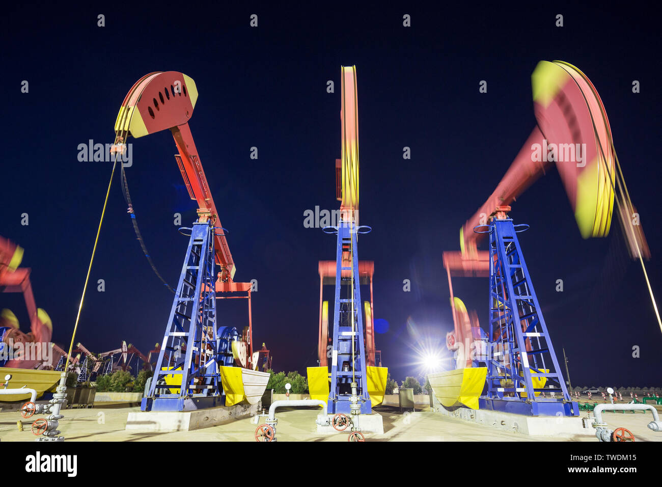 Oil-rig of oilfield day and night Stock Photo - Alamy