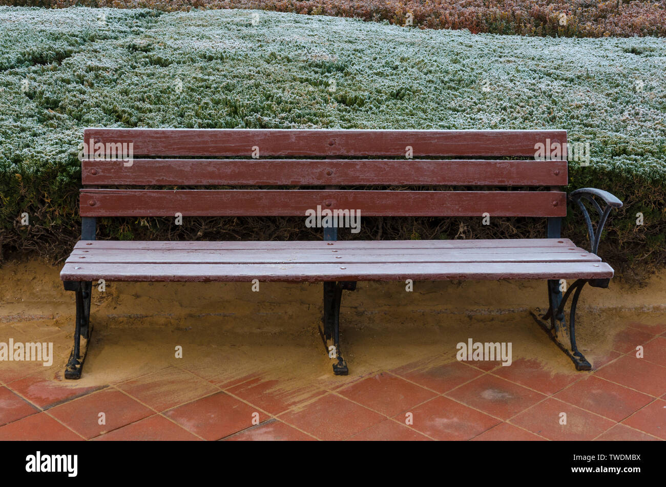 A bench on the side of the road in winter Stock Photo - Alamy