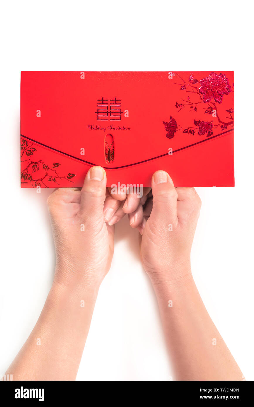 Hands holding invitation close-up on white background Stock Photo - Alamy