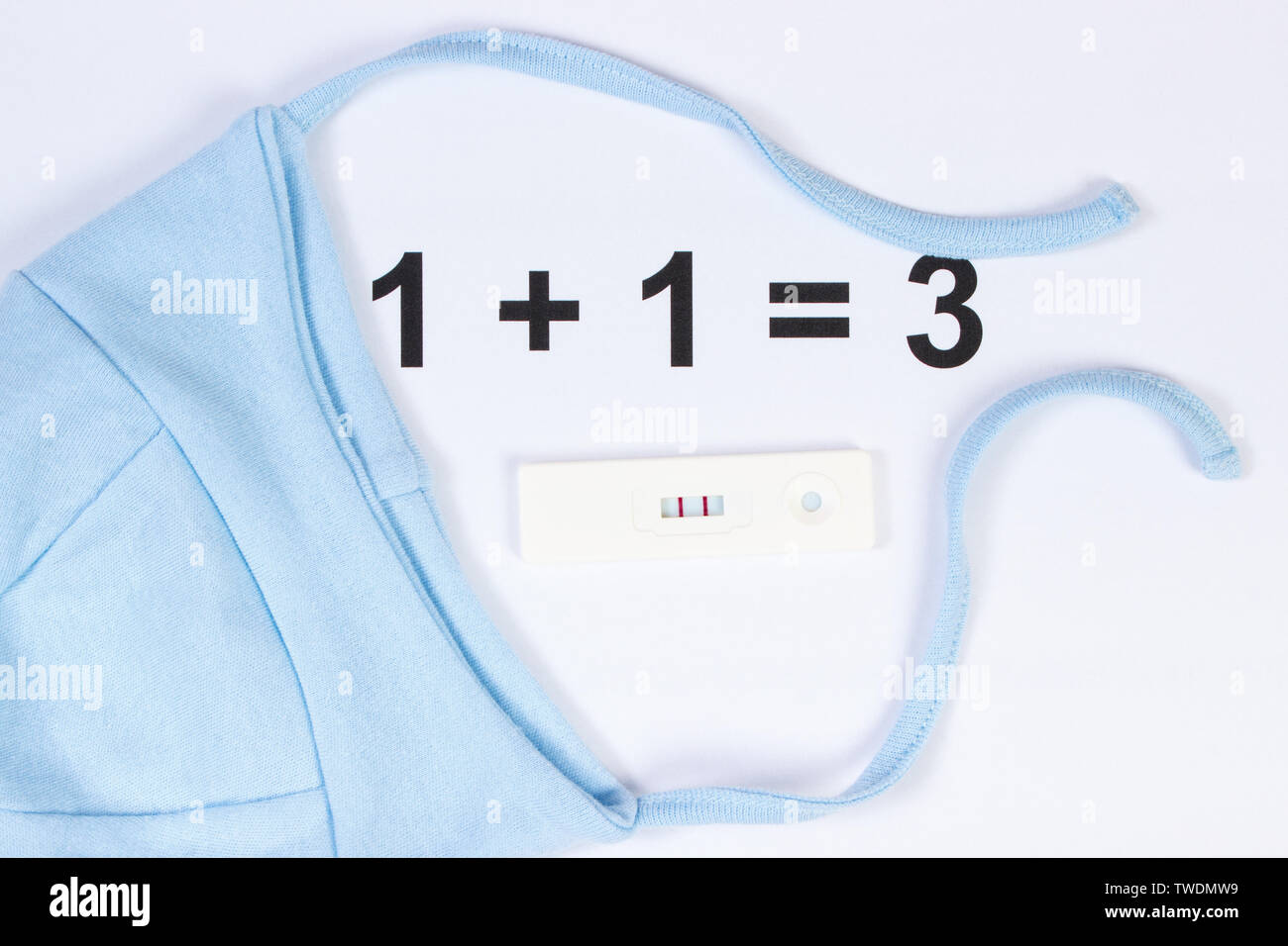 Pregnancy test with positive result and cap for newborn, concept of ...