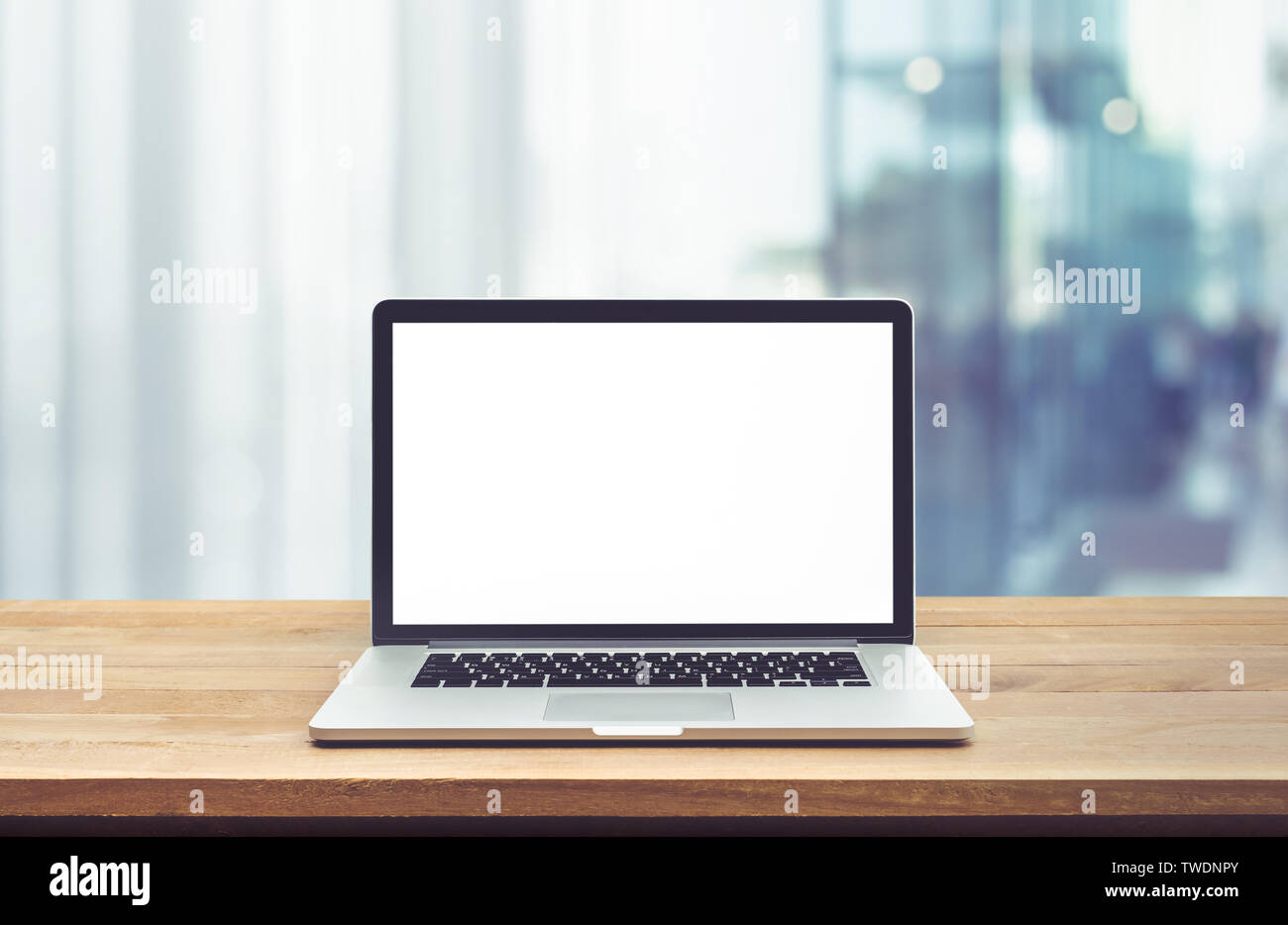 Modern computer,laptop with blank screen on counter bar(retail store ...