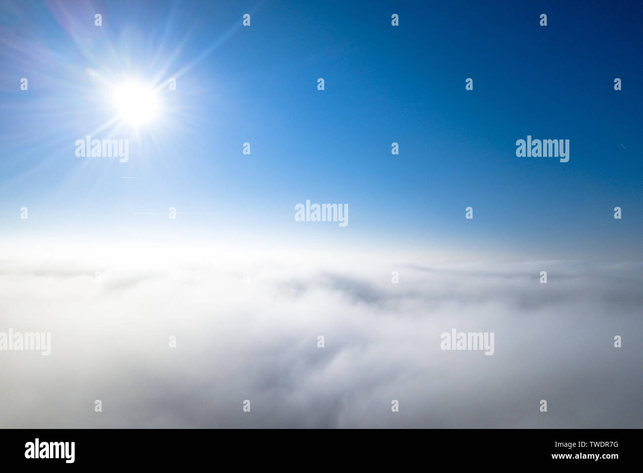 Aerial view of mist layer from above looking like sun shining above ...