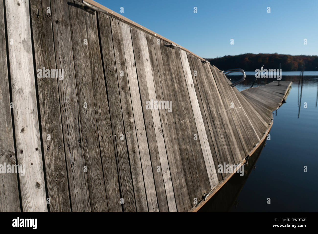 Storm-damaged wooden dock on a lake in need of repair in Lake Wheeler ...