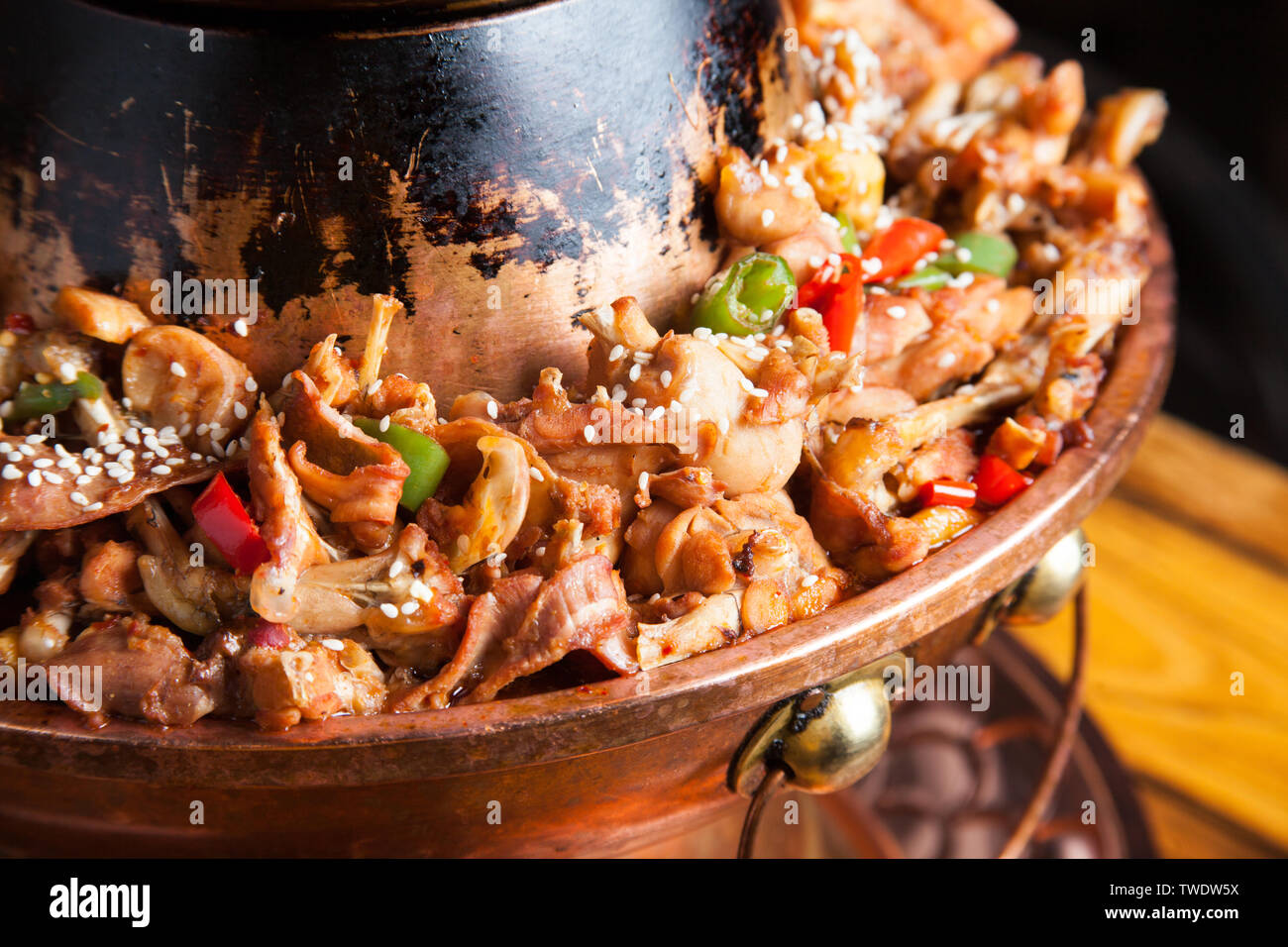 Charcoal fire frog pot field chicken meal Stock Photo - Alamy