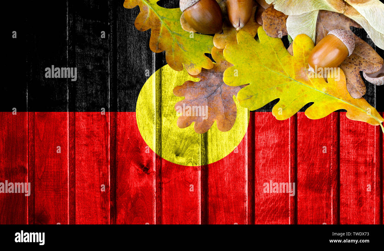 Australian Aboriginal flag on autumn wooden background with leaves and ...