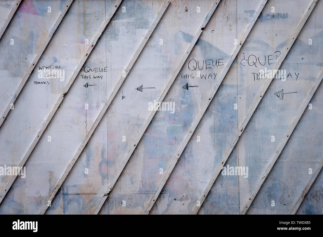 Direction For Forming A Queue Indicated On A Hoarding Stock Photo - Alamy
