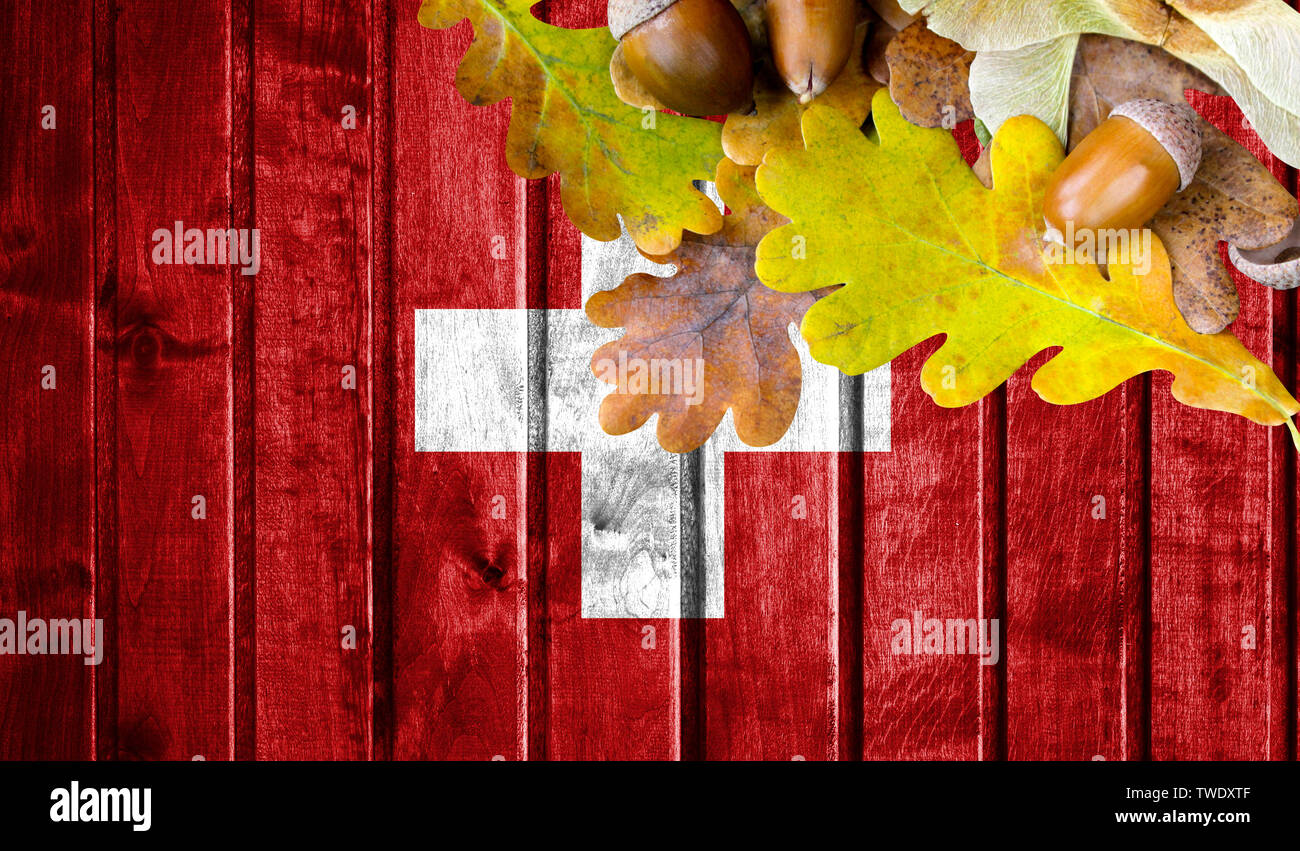 Switzerland flag on autumn wooden background with leaves and good place ...