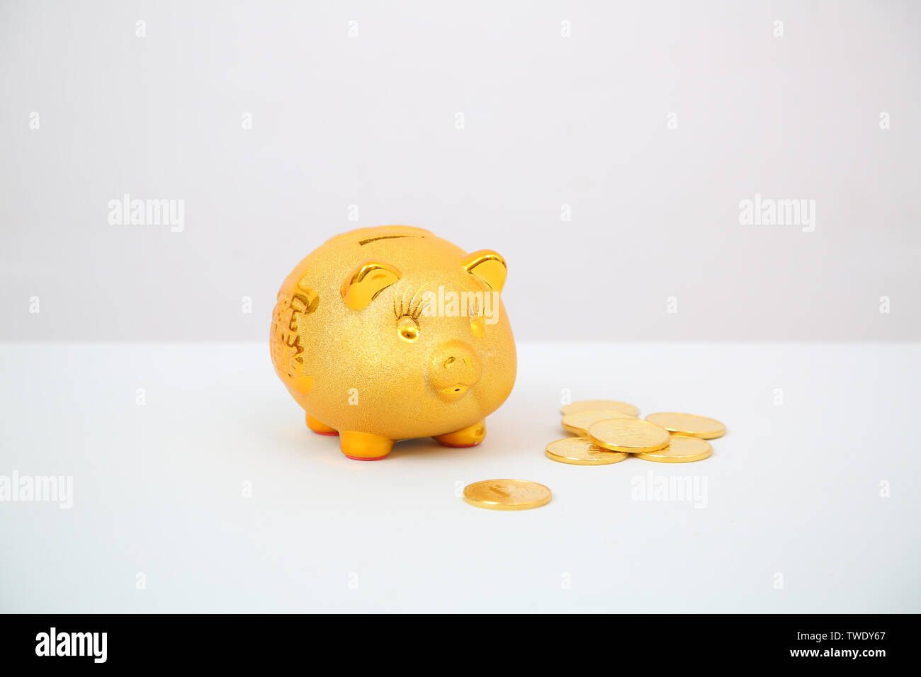 Savings pot gold coins Stock Photo - Alamy