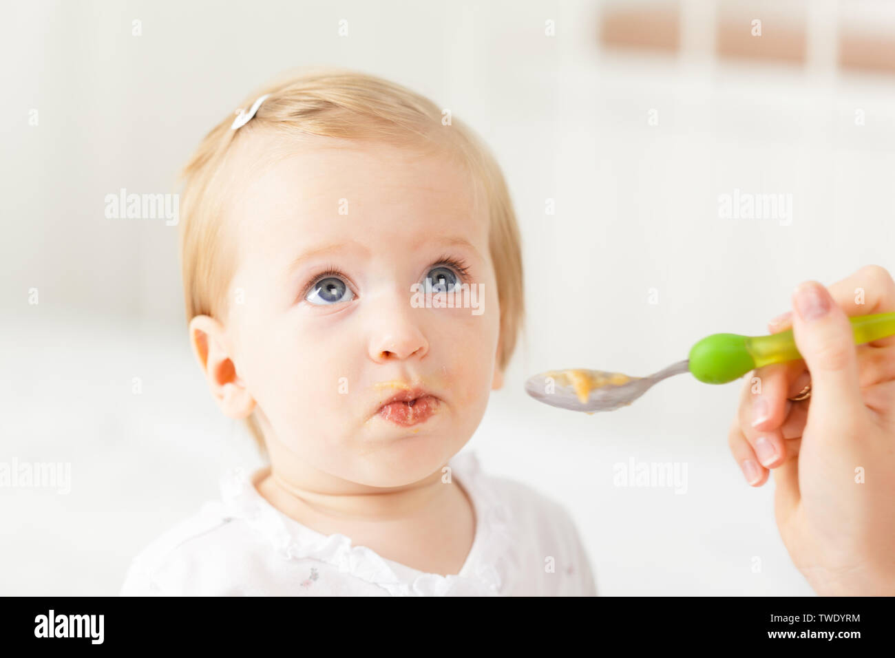Little baby feeding with a spoon Stock Photo - Alamy