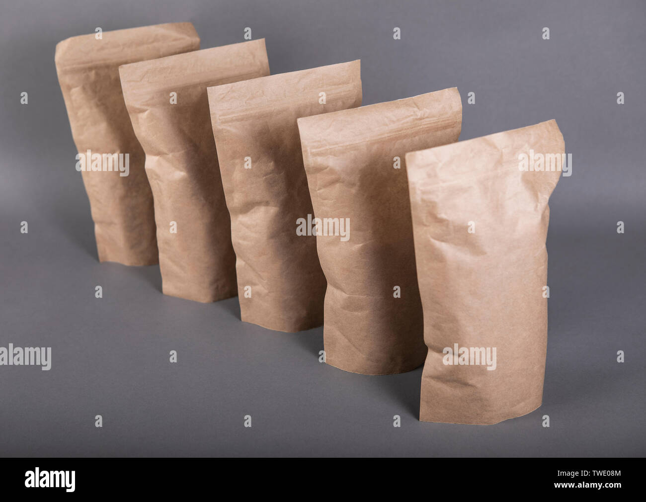 Mockup craft paper pouch bag over gray Stock Photo - Alamy