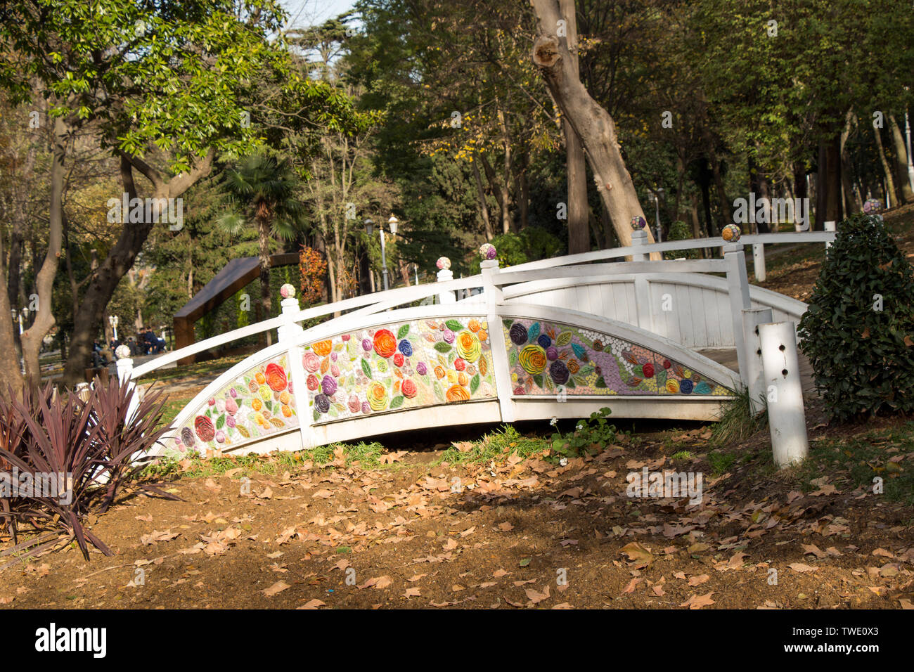 Wooden white bridge with colorful flowers ornated on it on display ...