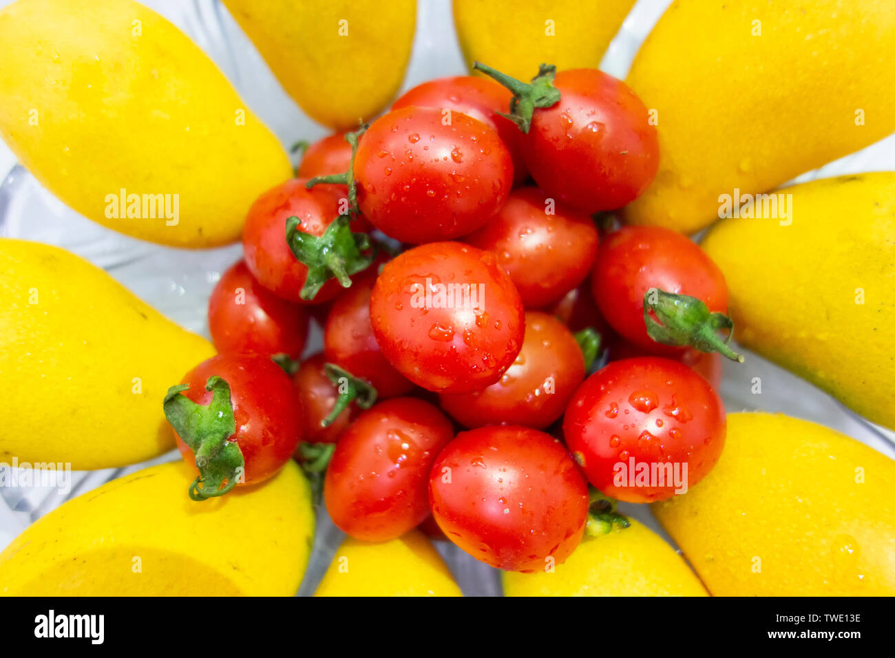 Mango and small tomatoes Stock Photo - Alamy