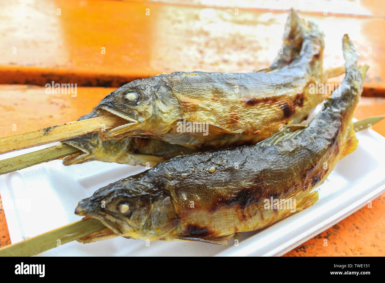 Grilled Ayu fish with salt at Kegon Waterfall, Nikko, Japan Stock Photo ...