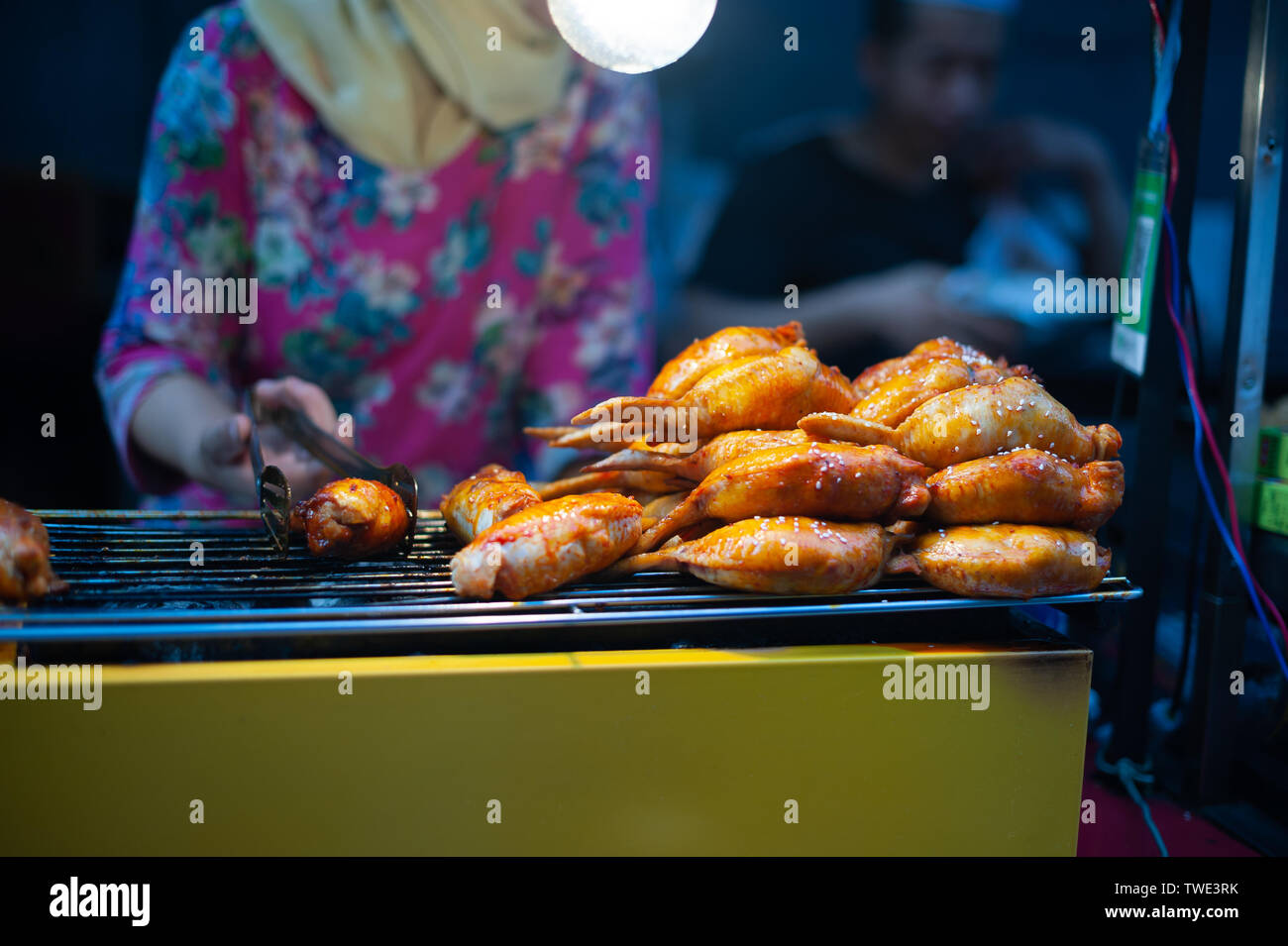 Xi'an,Shaaxi province,China - Aug 14,2018: Woman cooking chicken in a ...