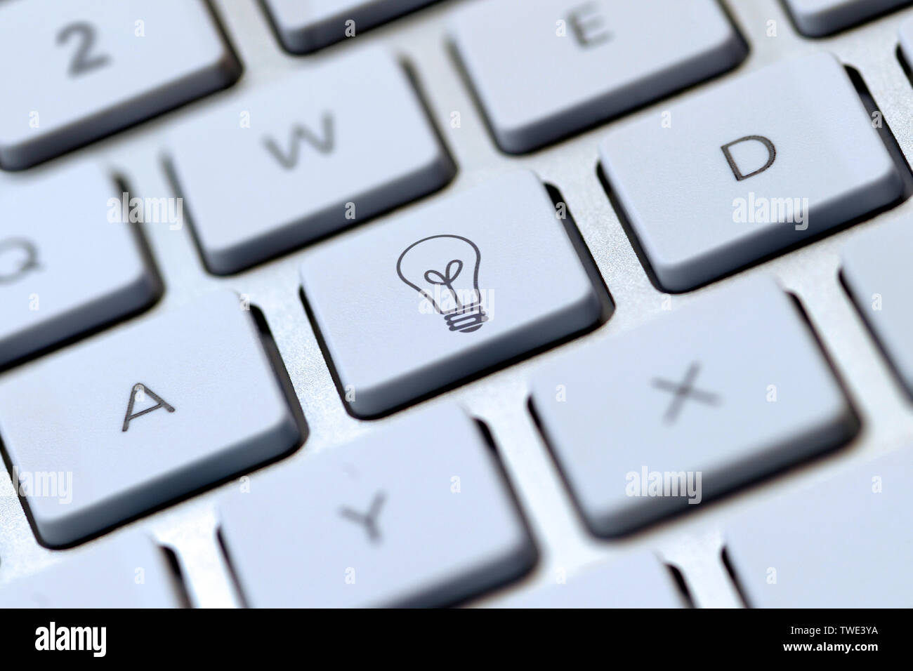 Lightbulb symbol on a laptop keypad Stock Photo - Alamy