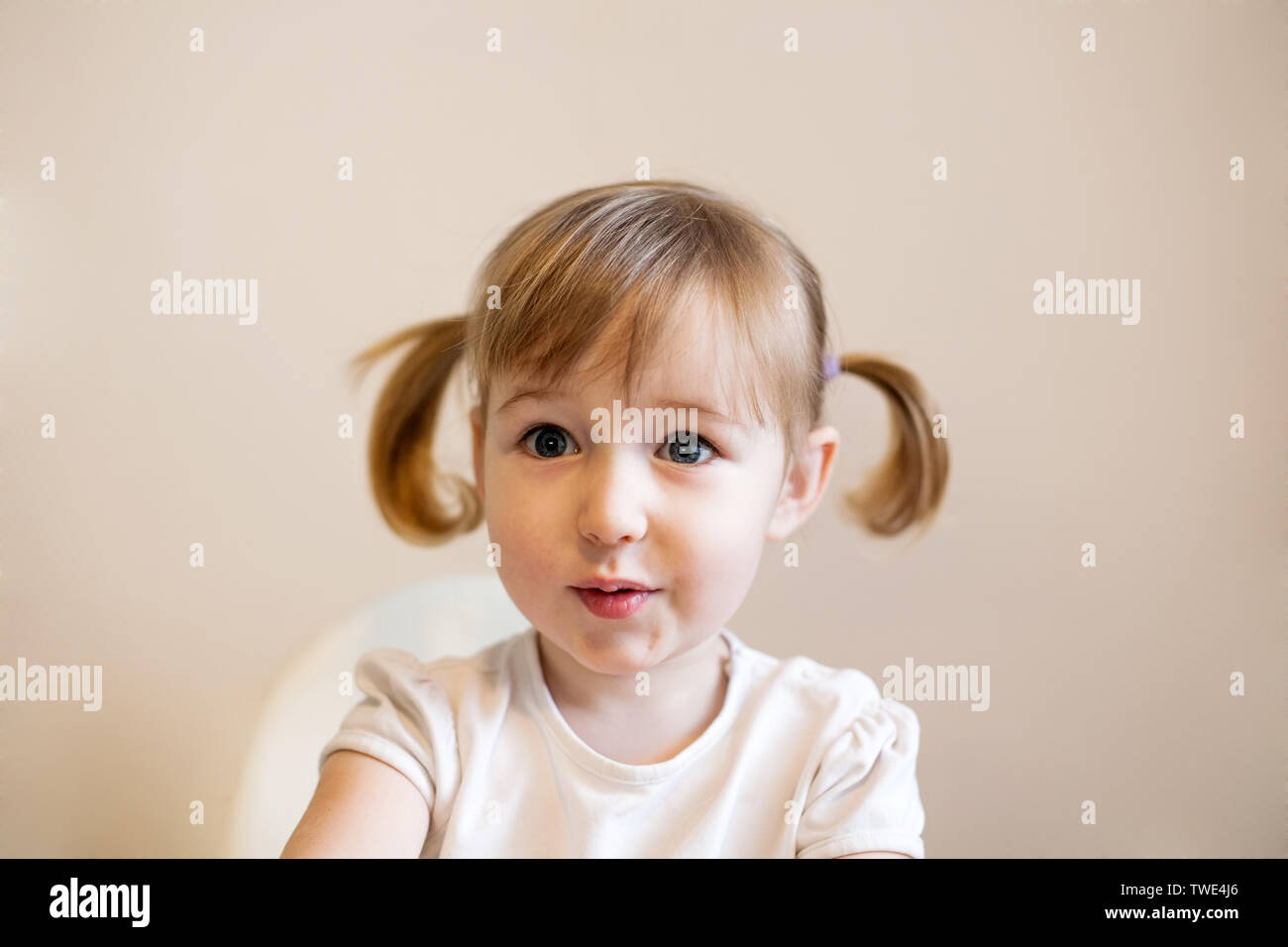 little surprised kid Caucasian girl with wide-open eyes cute closeup ...