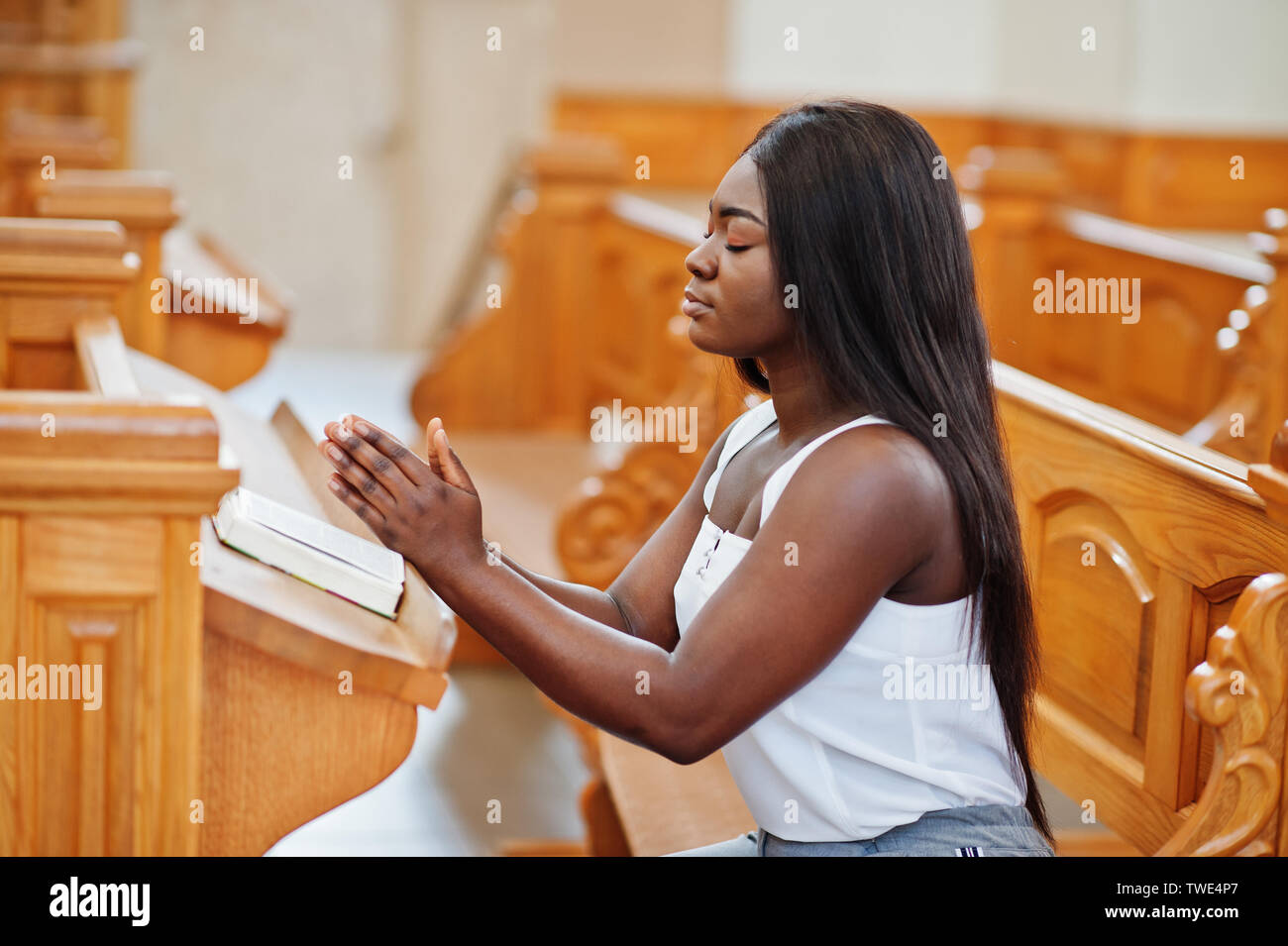 African american woman praying in the church. Believers meditates in ...