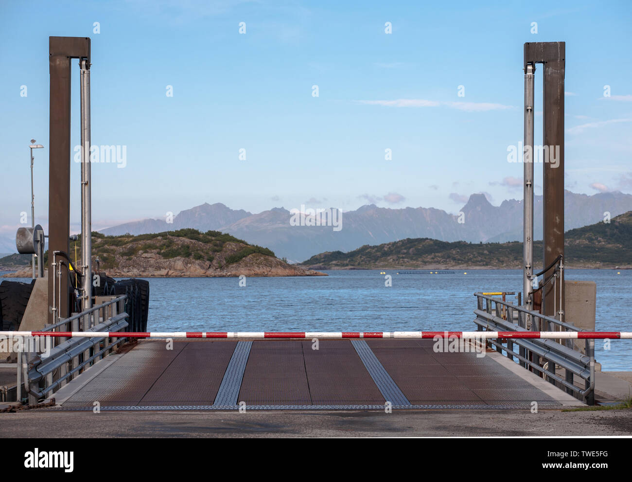 ferry gate closed with turnpike on sea and mountains horizon background ...