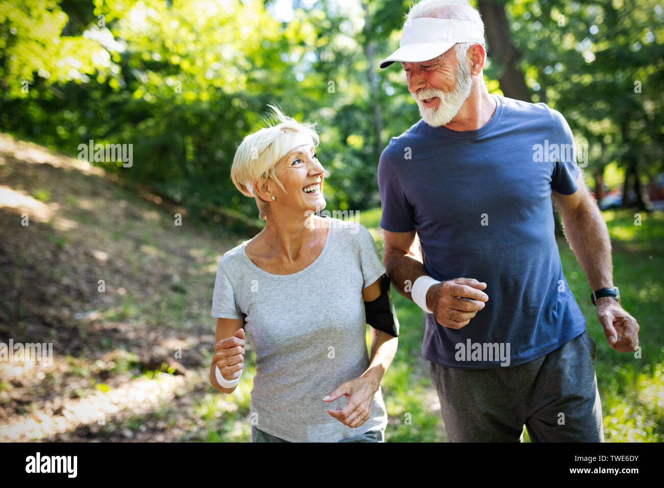 Mature couple jogging and running outdoors in nature Stock Photo - Alamy