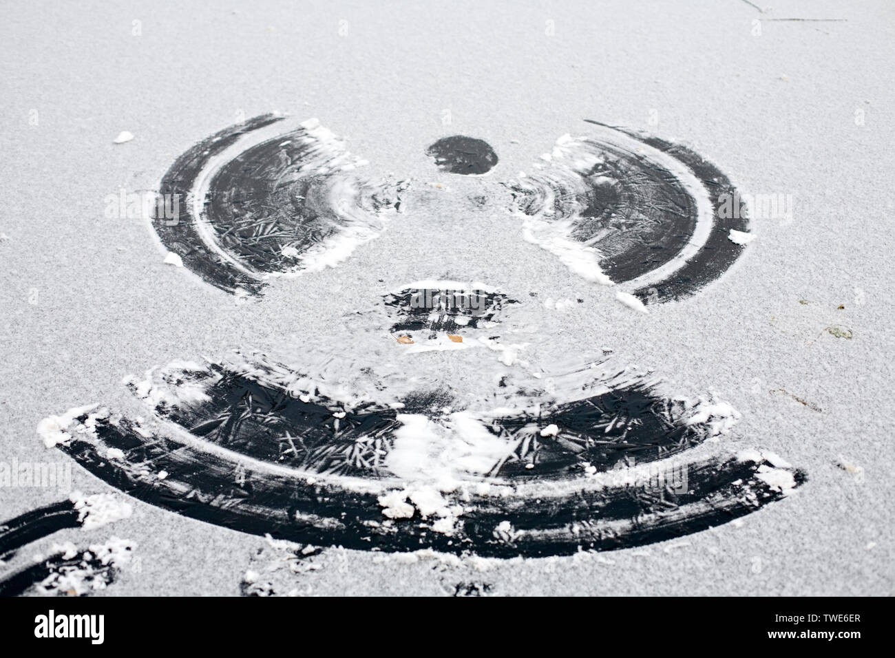 snow angel silhouette imprint on frozen lake surface Stock Photo - Alamy