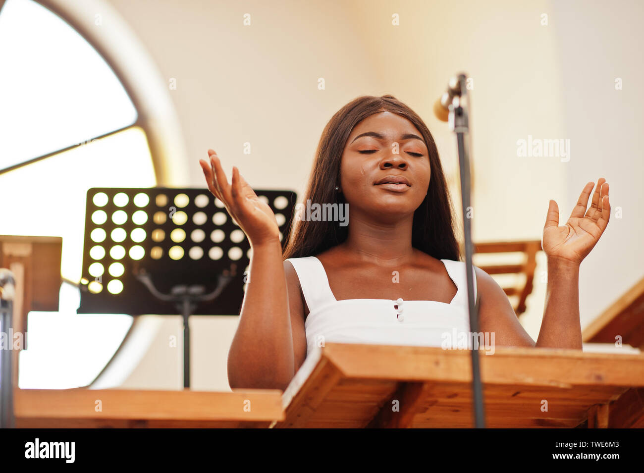 African american woman praying in the church. Believers meditates in ...