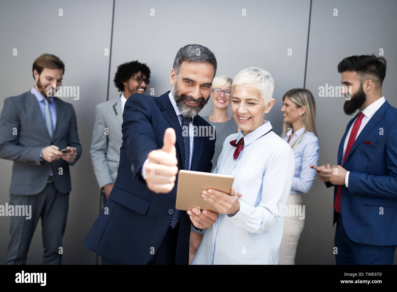Successful company with happy workers in office Stock Photo - Alamy