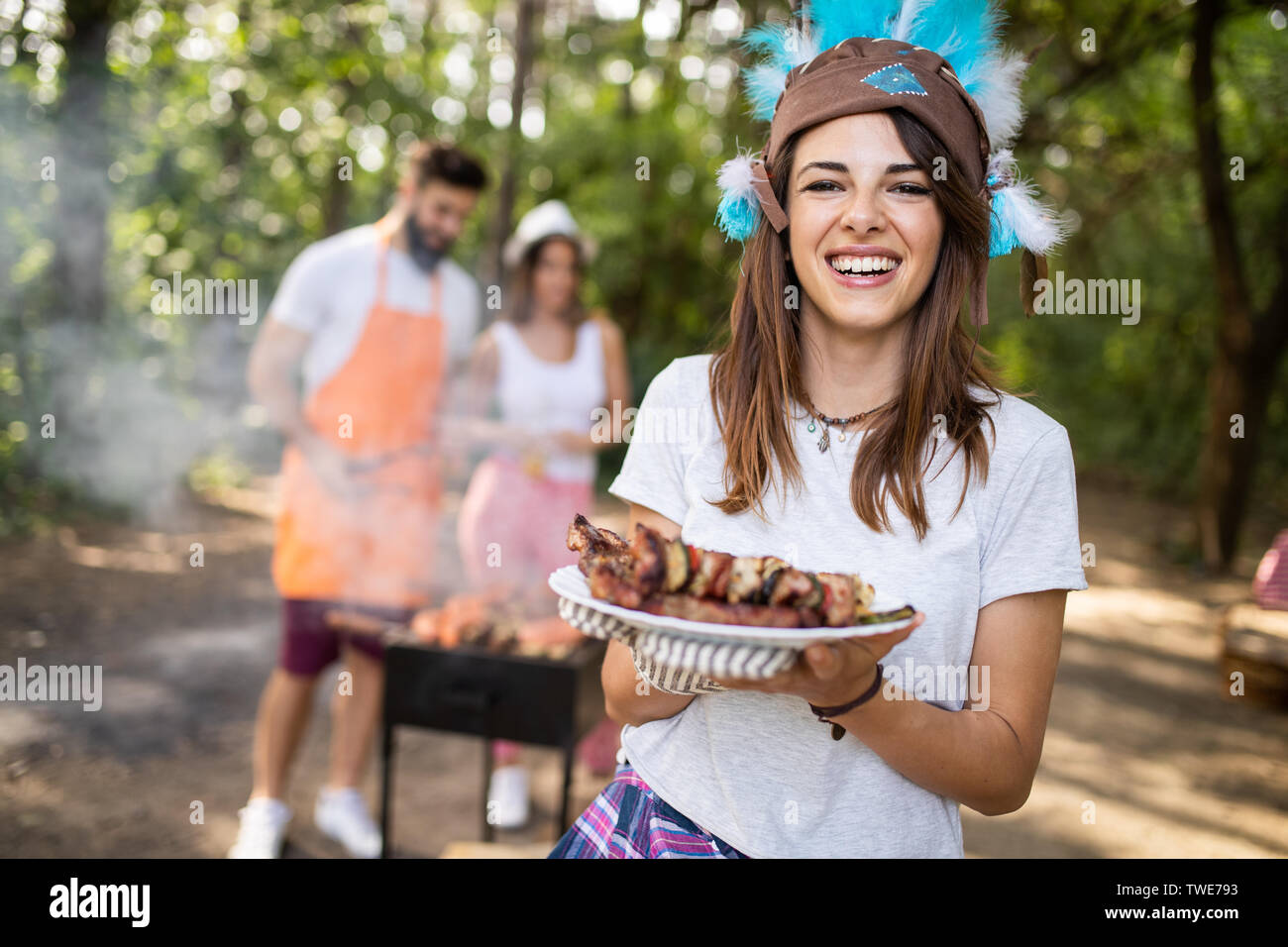 Happy friends enjoying barbecue and grill party outdoor Stock Photo - Alamy