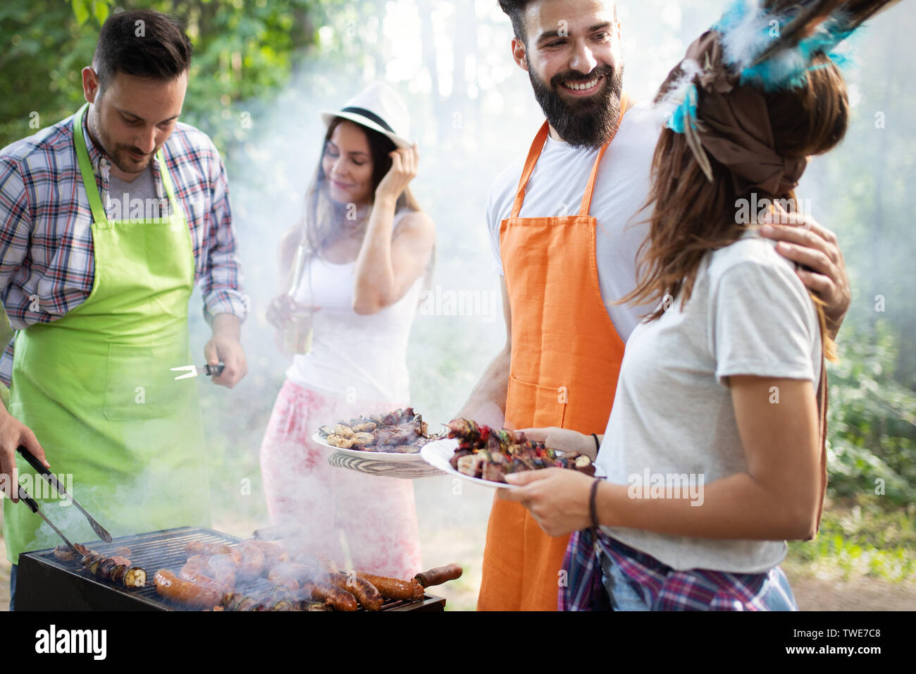 Group of friends having a barbecue party in nature Stock Photo - Alamy