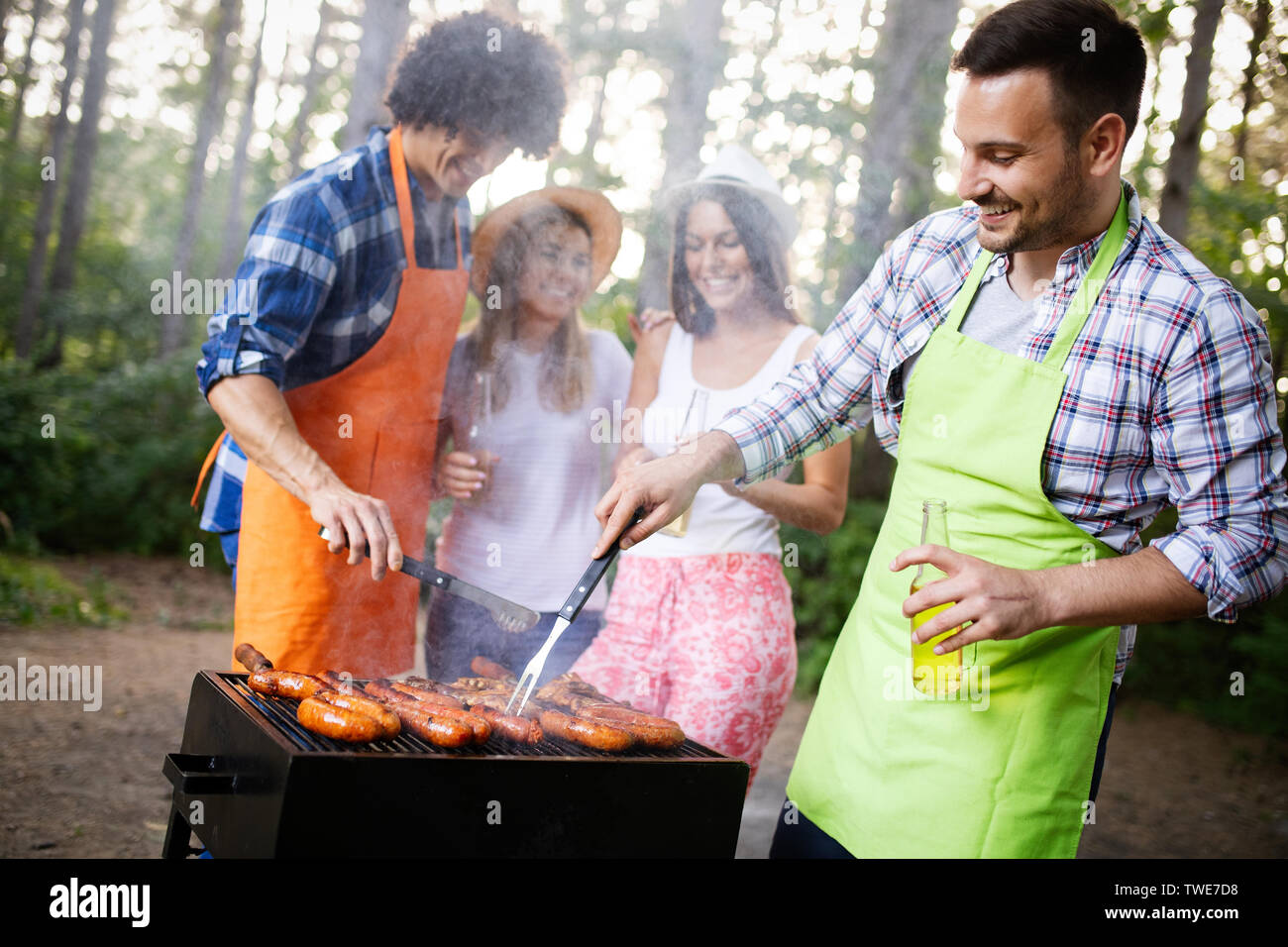 Group of happy friends having a barbecue party in nature Stock Photo ...