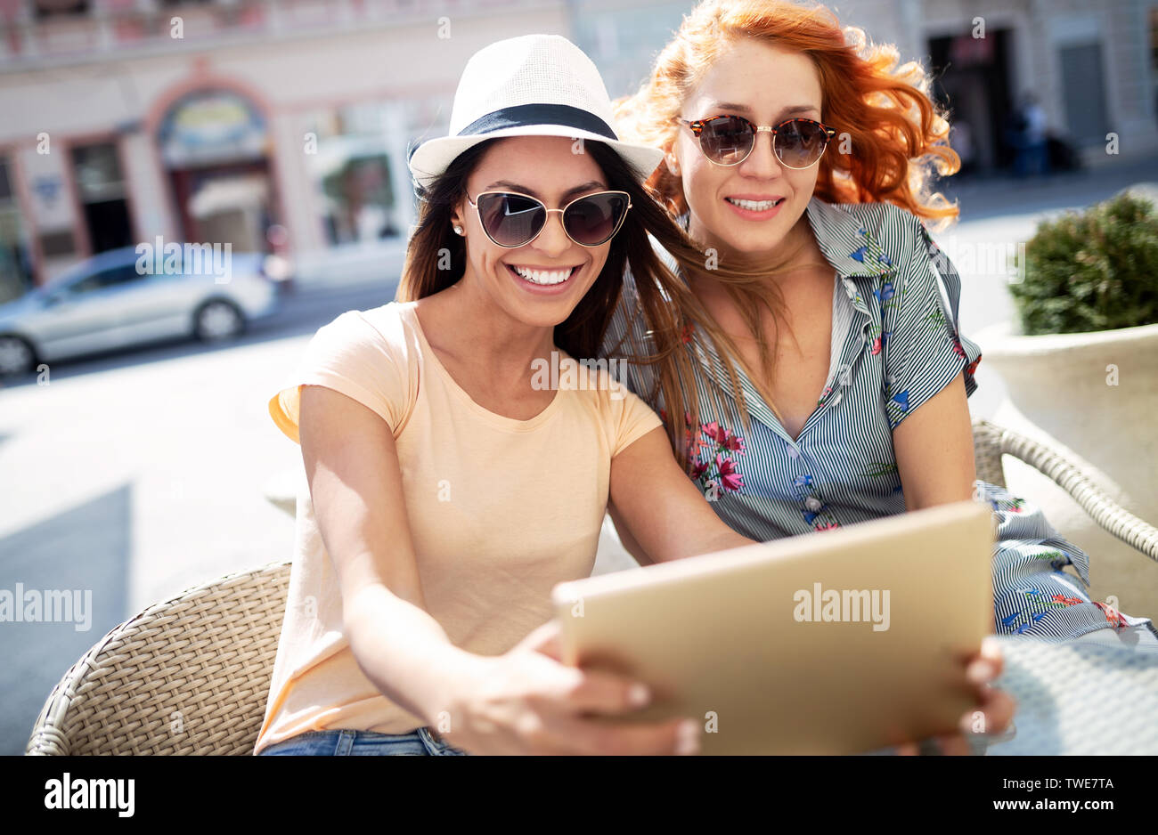 Beautiful girls having fun smiling together in a cafe outdoor Stock ...