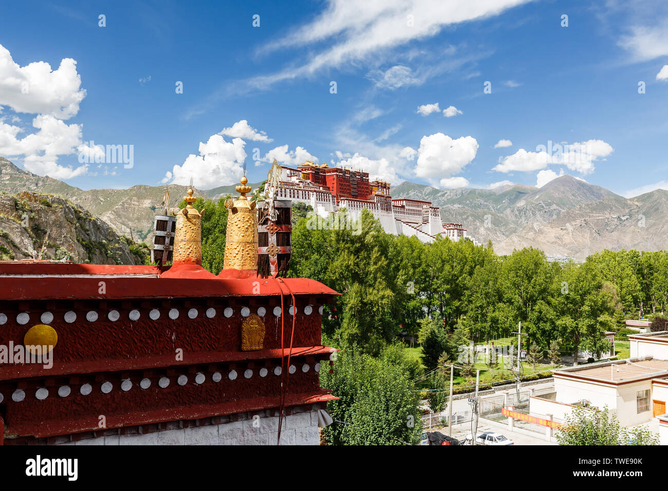View on Potala Palace with golden prayer wheel in the foreground ...