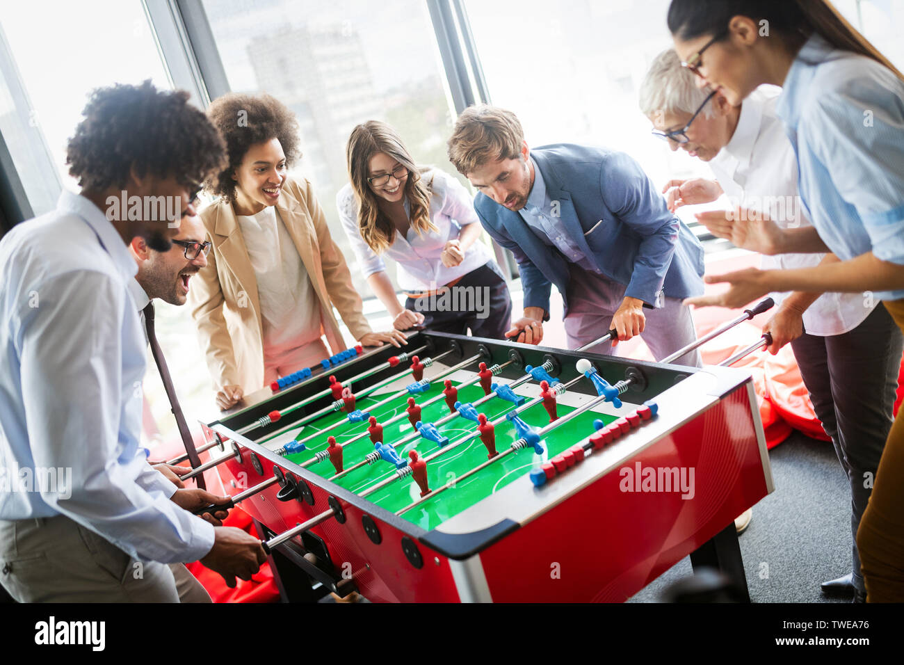 Business people having great time together.Colleagues playing table ...