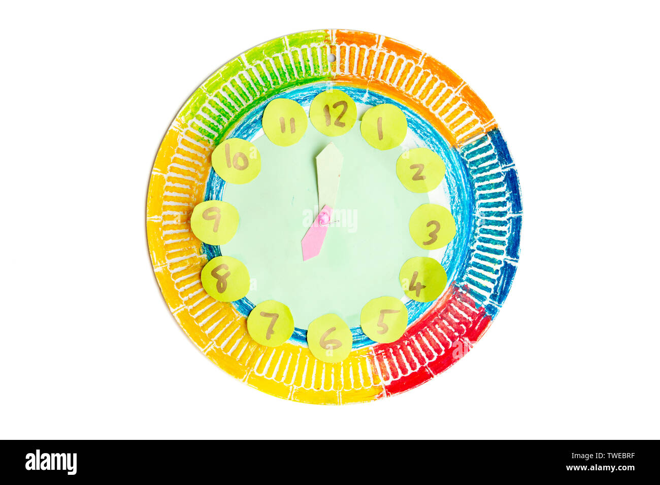 Colorful child handwork clock pointing at 7 o'clock, isolated on white ...