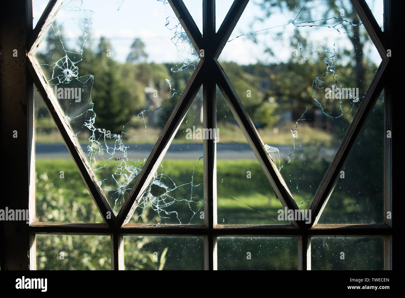 cracked and broken window glass punched by a pistol bullet Stock Photo ...