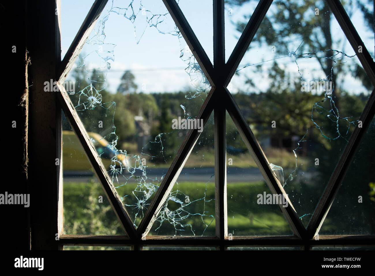 cracked and broken window glass punched by a pistol bullet Stock Photo ...