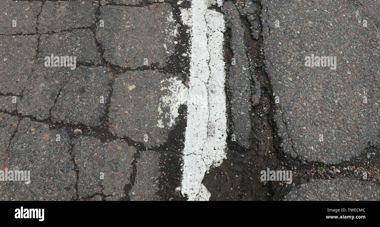 cracked and old asphalt with one solid white line Stock Photo - Alamy