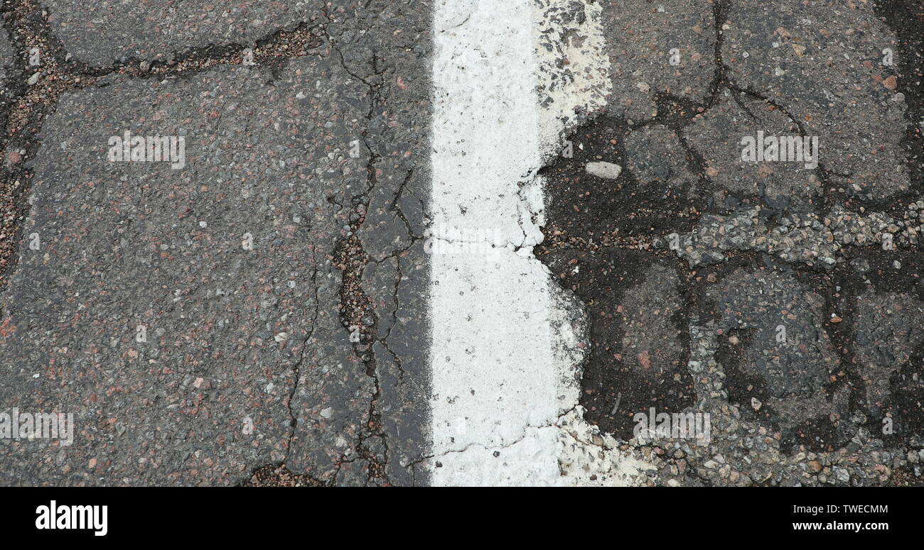 cracked and old asphalt with one solid white line Stock Photo - Alamy