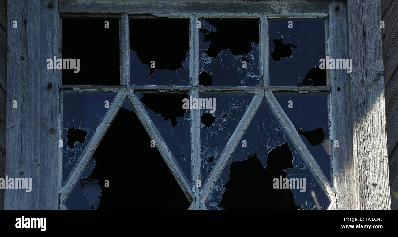 cracked and broken window glass punched by a pistol bullet Stock Photo ...