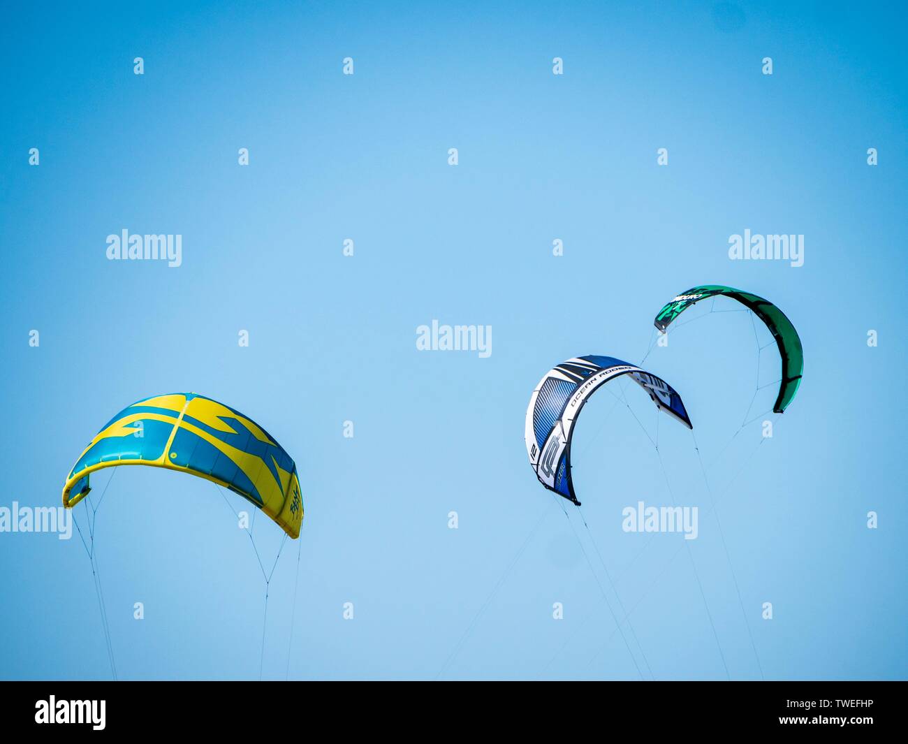 Three kites against a clear blue sky in summer Stock Photo - Alamy