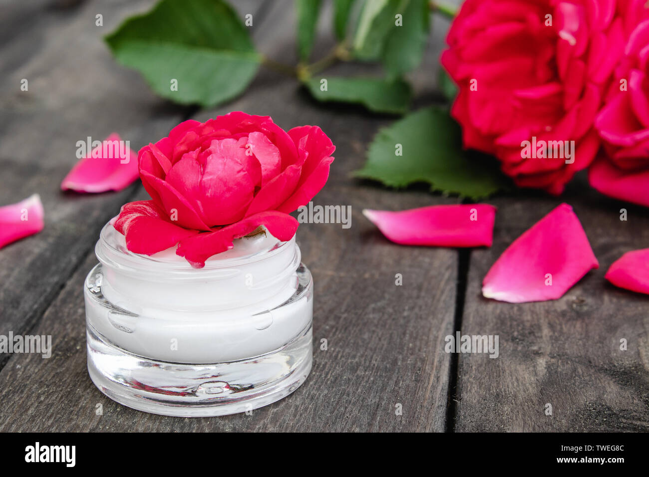 Natural flower cosmetics with red pink flowers for face and body care ...