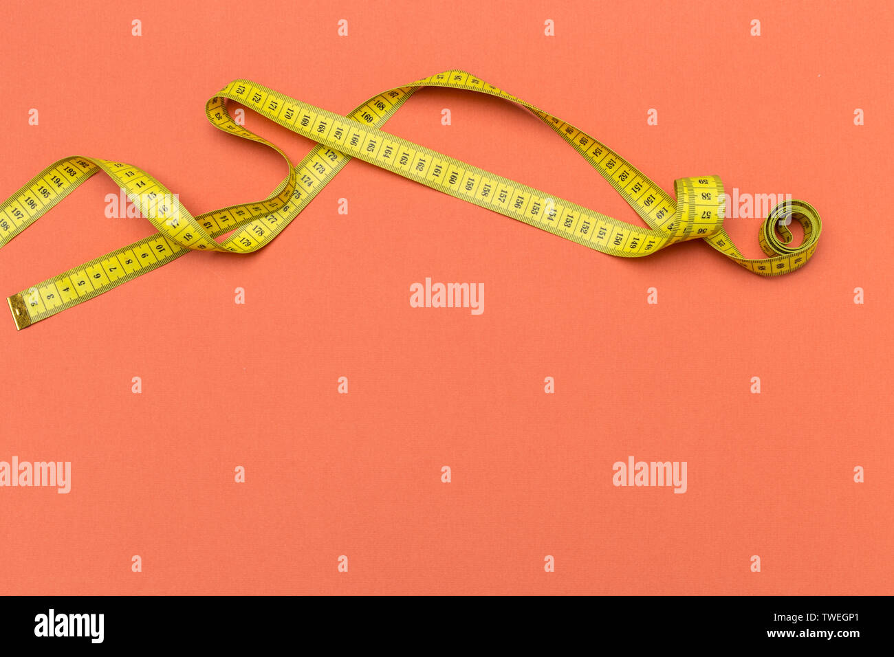 Yellow plastic measuring tape top view Stock Photo - Alamy