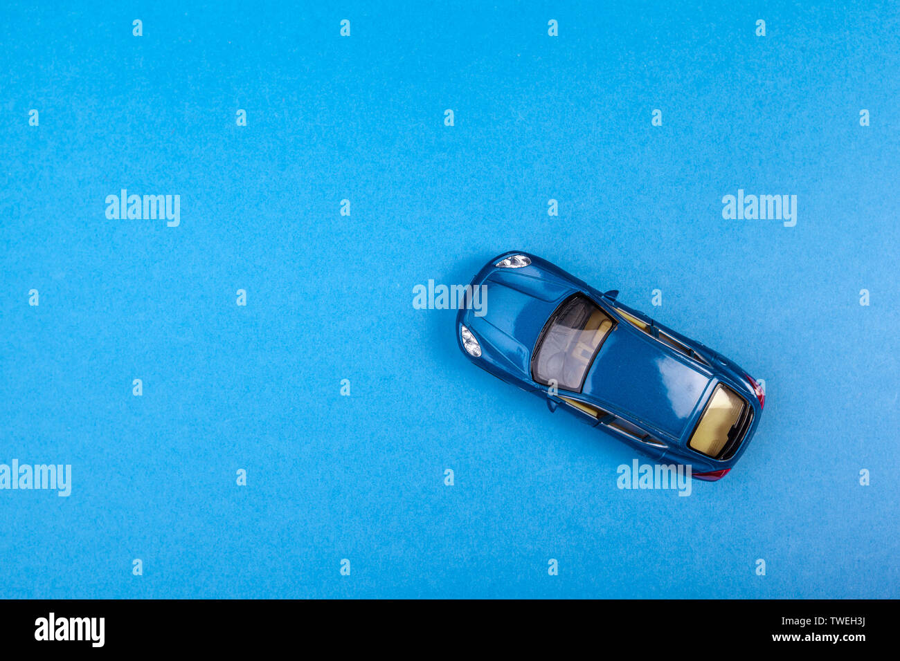 Blue toy car on blue colored background Stock Photo - Alamy
