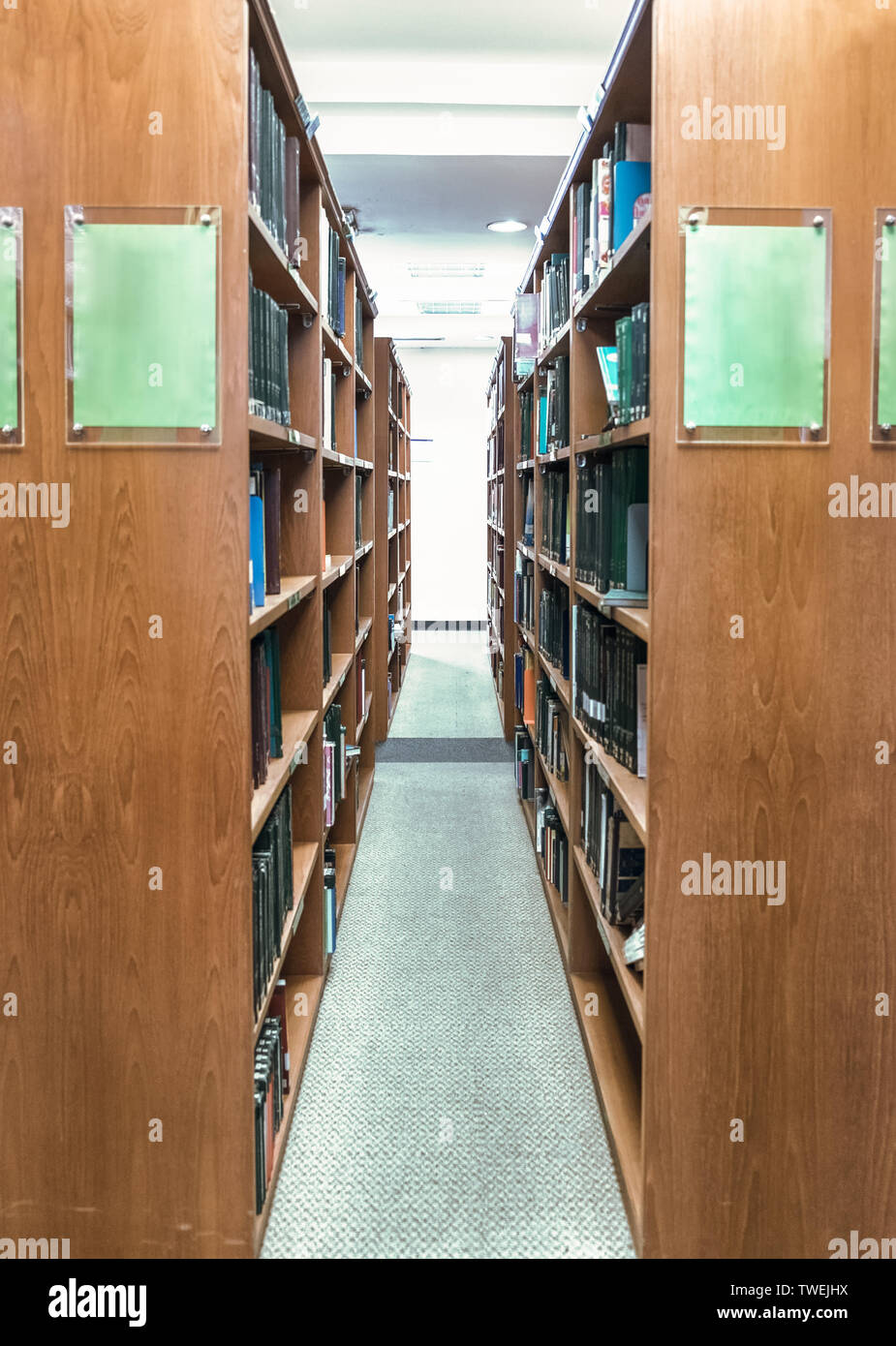 Bookshelf brown channel box in library Stock Photo - Alamy