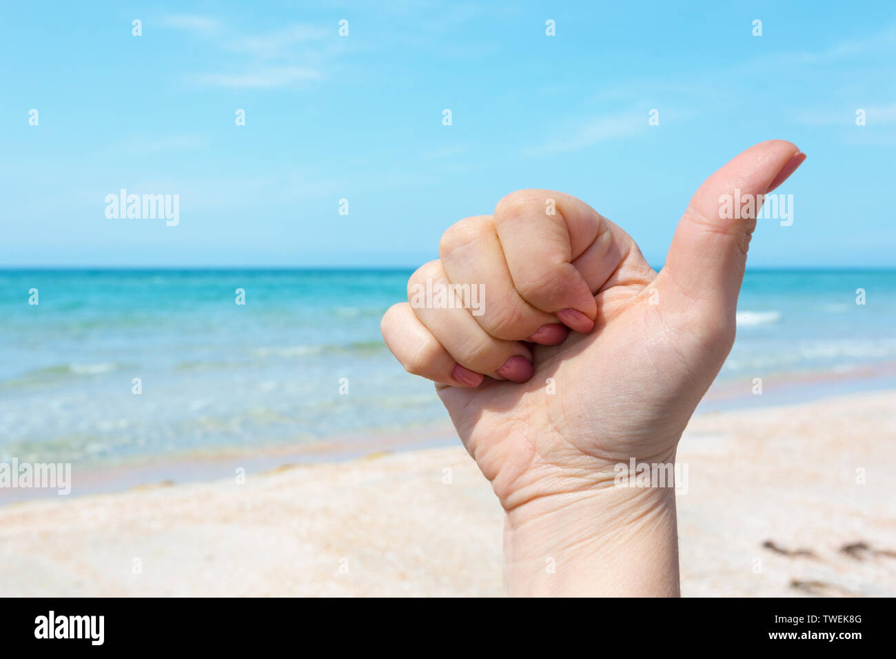 hand sign over blue sea and sky background, summer travel, holiday ...